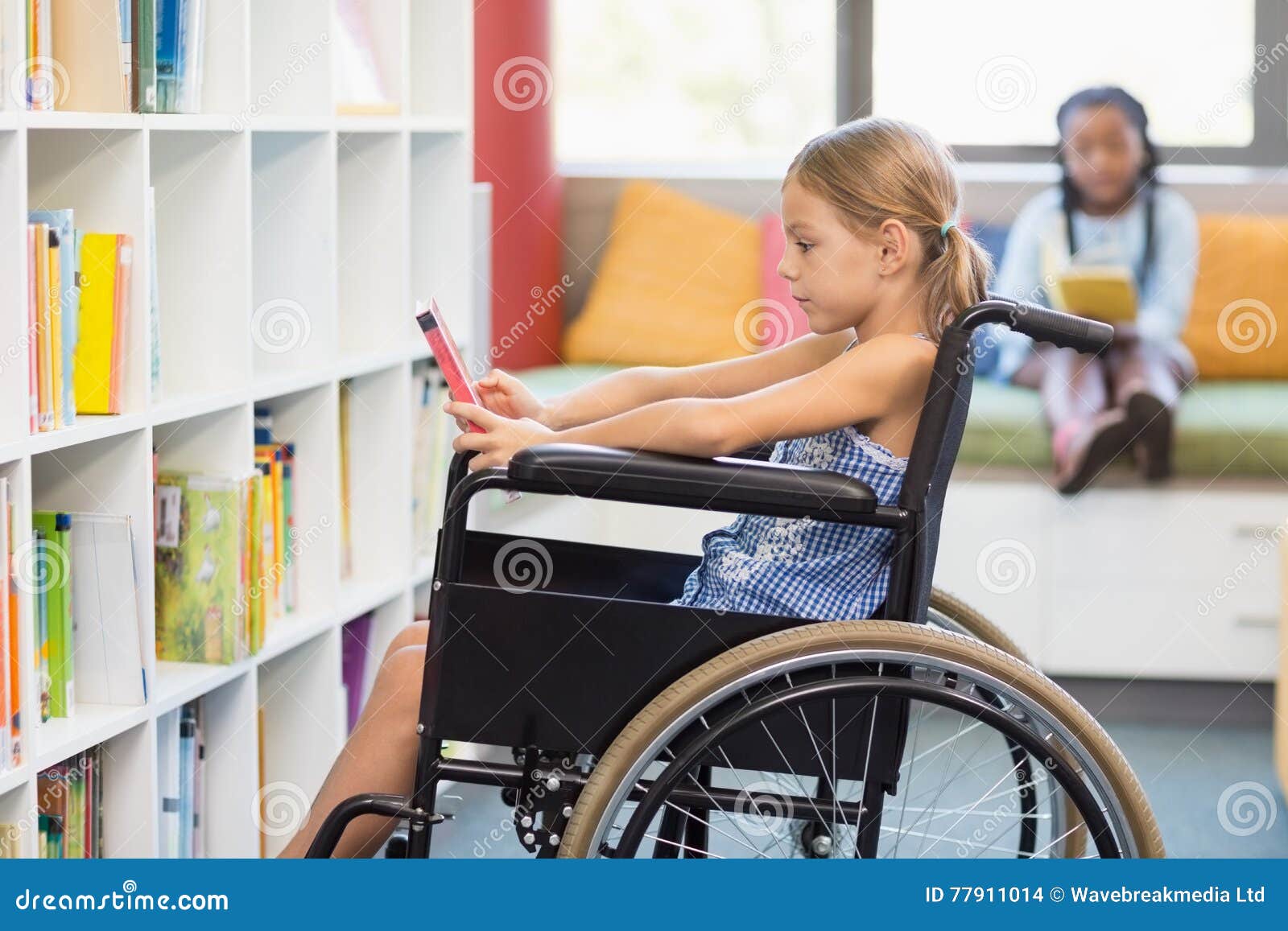 Disabled School Girl Selecting a Book from Bookshelf in Library Stock ... Disabled School Girl Selecting a Book from Bookshelf in Library Stock ...