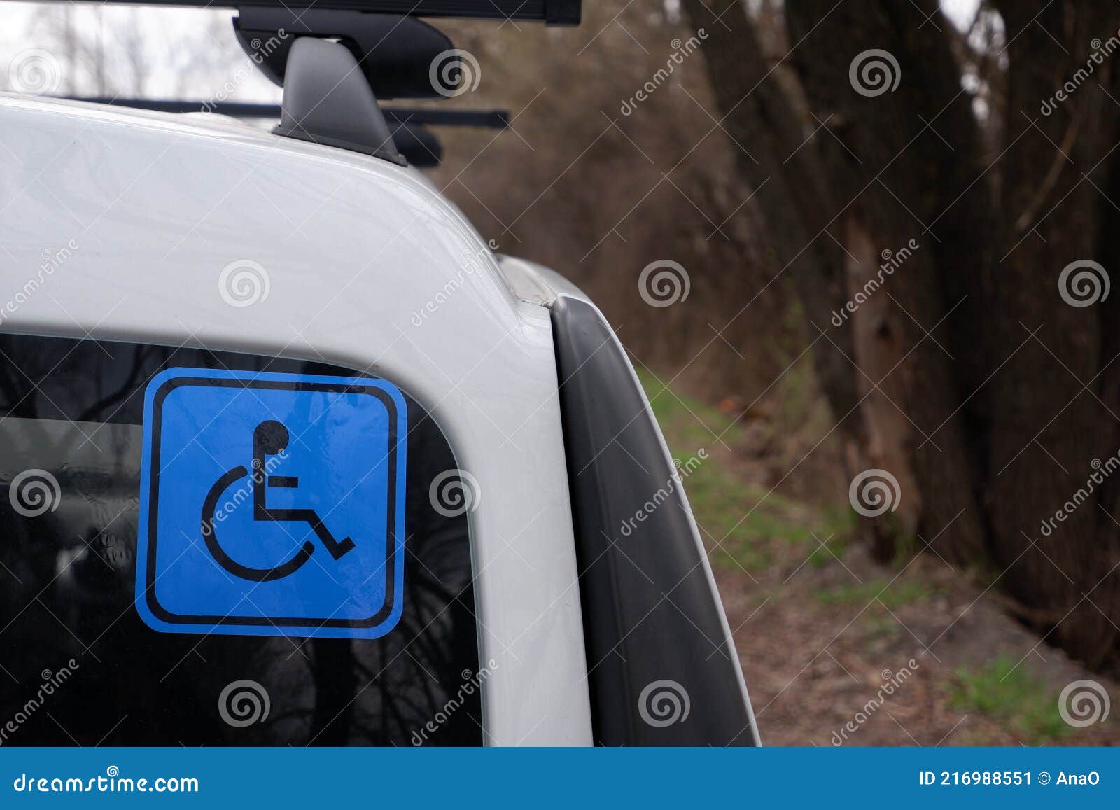 Disabled Sign on a Car. Blue Sticker on the Rear Window of a White Car ...