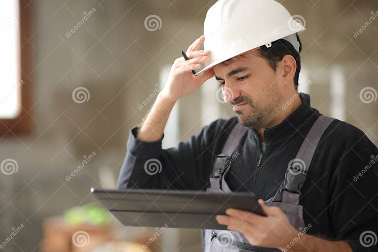 Disappointed Construction Worker Checking Tablet Stock Image - Image of ...
