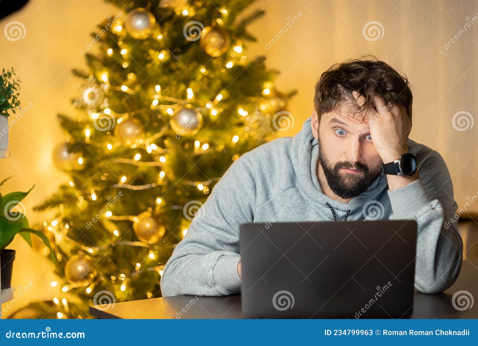 A Disappointed Man Sits in Front of a Computer on New Year`s Eve in the ...