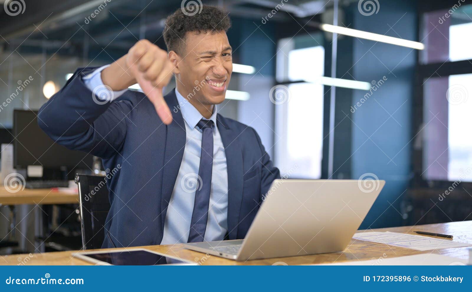 Disappointed Young Businessman Doing Thumbs Down in Office Stock Photo ...