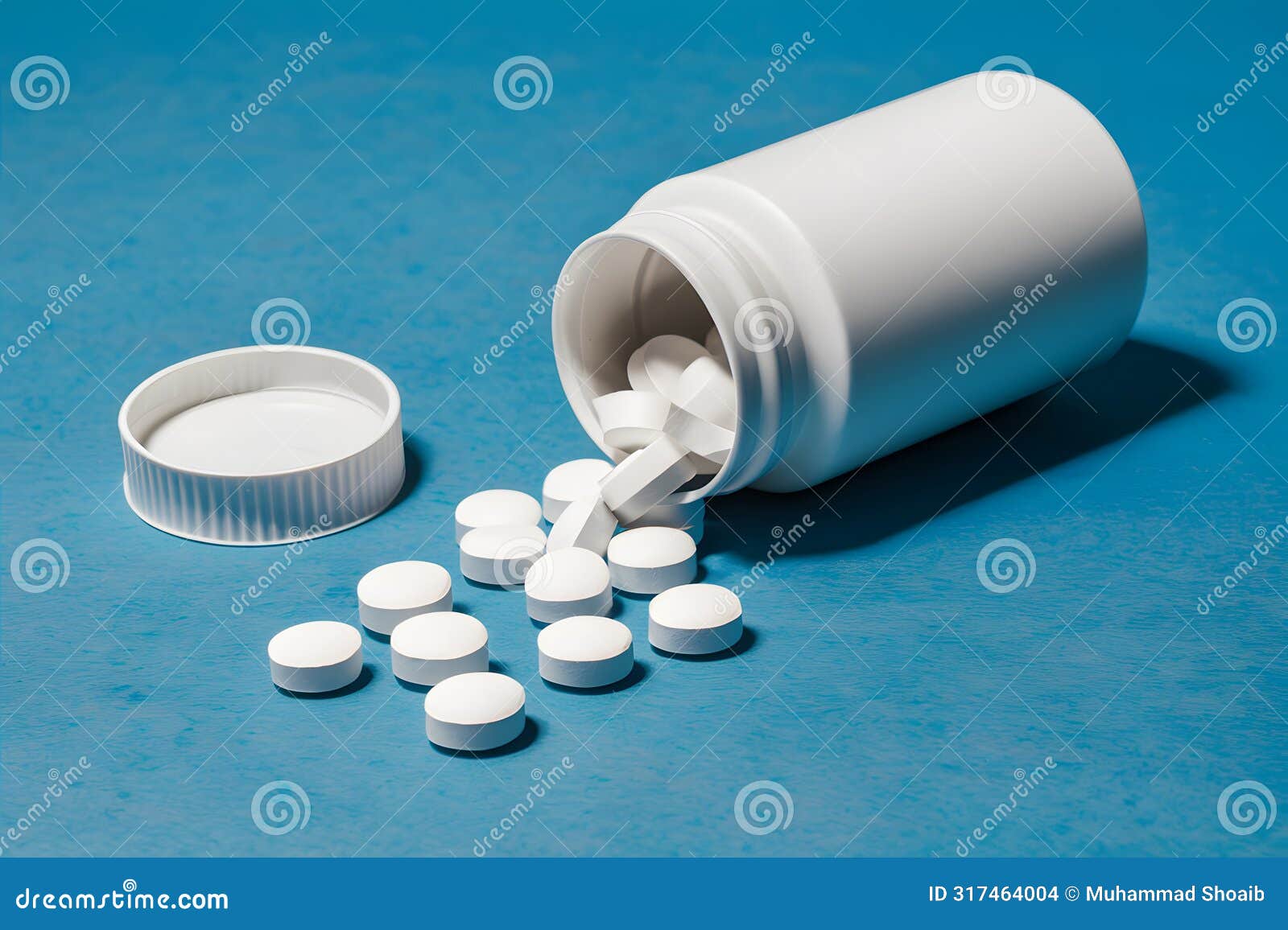 Disarrayed White Tablets Spilled from Cylindrical Container on Vibrant ...