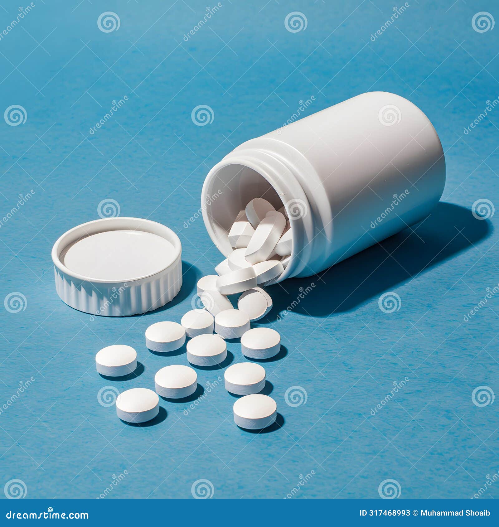 Disarrayed White Tablets Spilled from Cylindrical Container on Vibrant ...