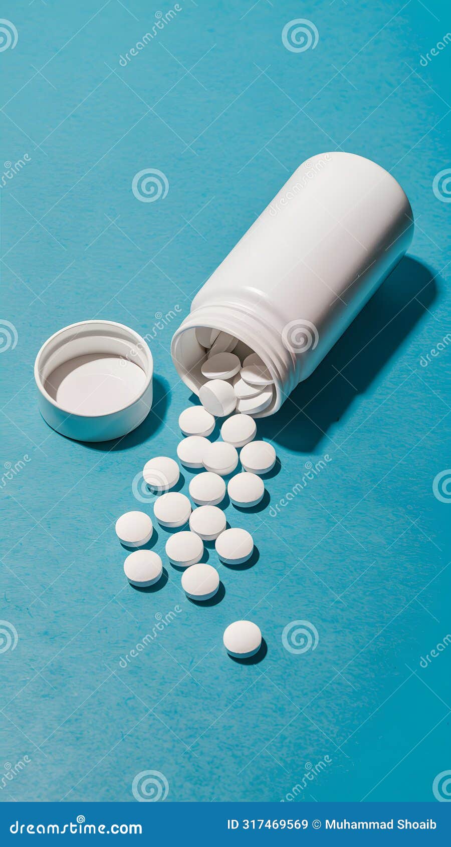 Disarrayed White Tablets Spilled from Cylindrical Container on Vibrant ...