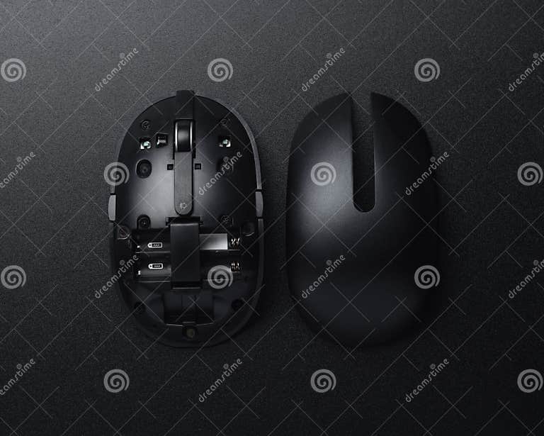 Disassembled Black Computer Mouse on a Black Plastic Background. Repair ...