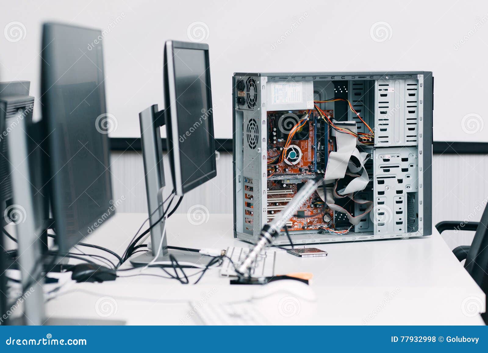 Disassembled Computer Unit on Table with Monitors Stock Photo - Image ...