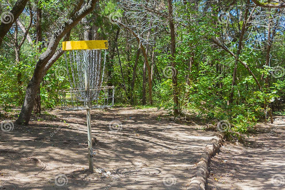 Disc golf basket and trees stock image. Image of leisure - 77089907