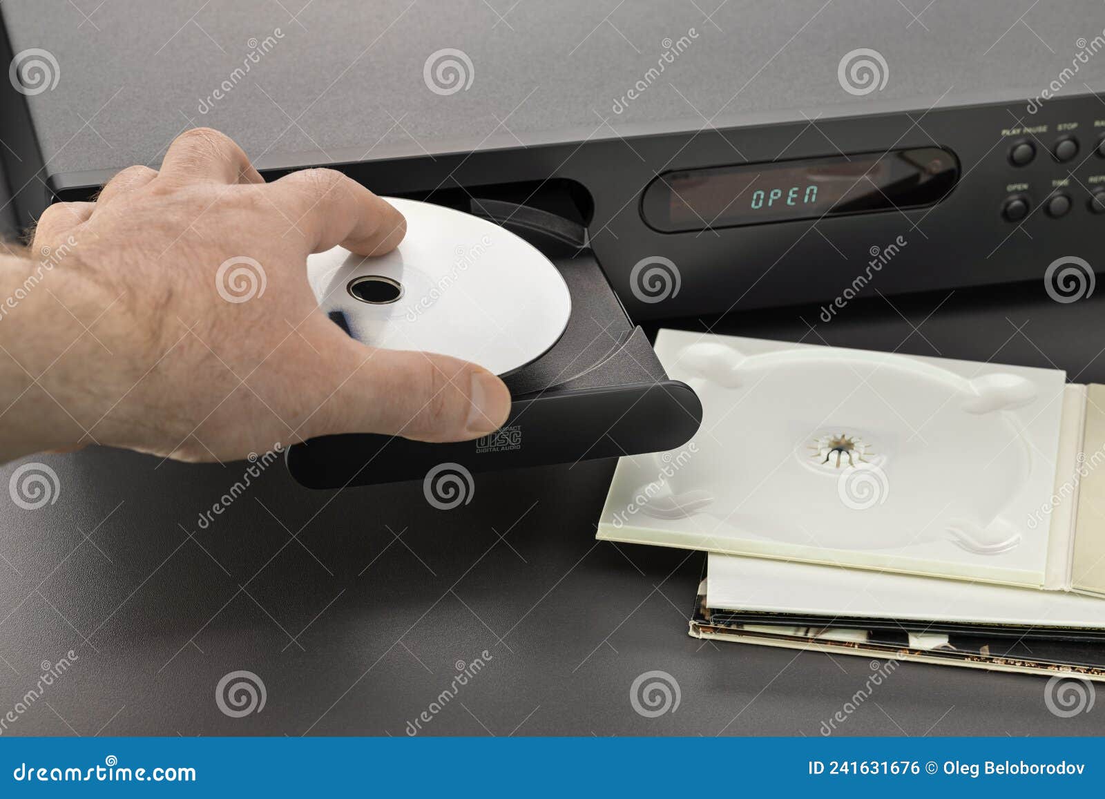 Hand of a Man with a Disc, an Open Tray of a CD Player. Stock Photo ...