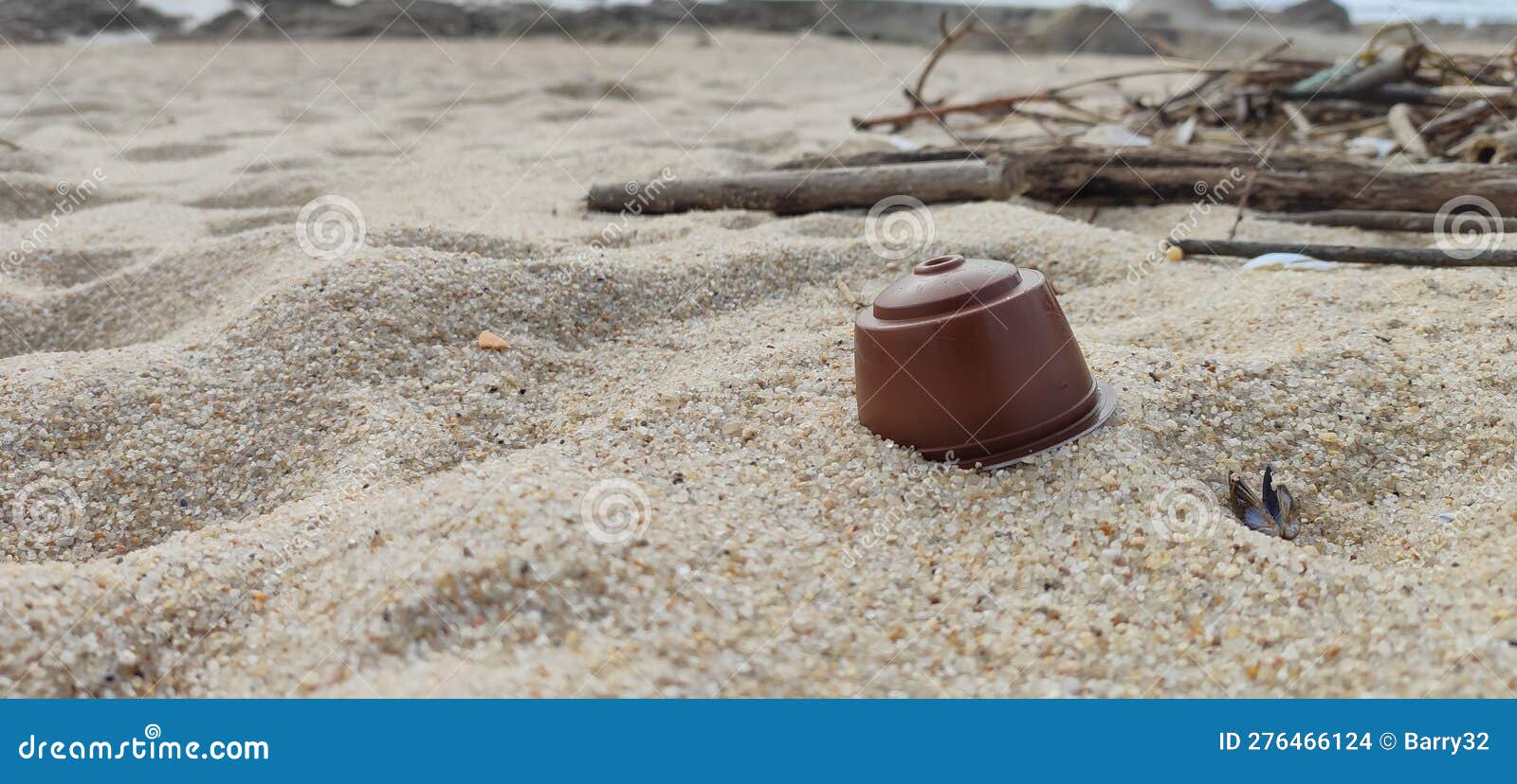Discarded Coffee Capsule Washed Up on Sandy Beach Stock Photo - Image ...
