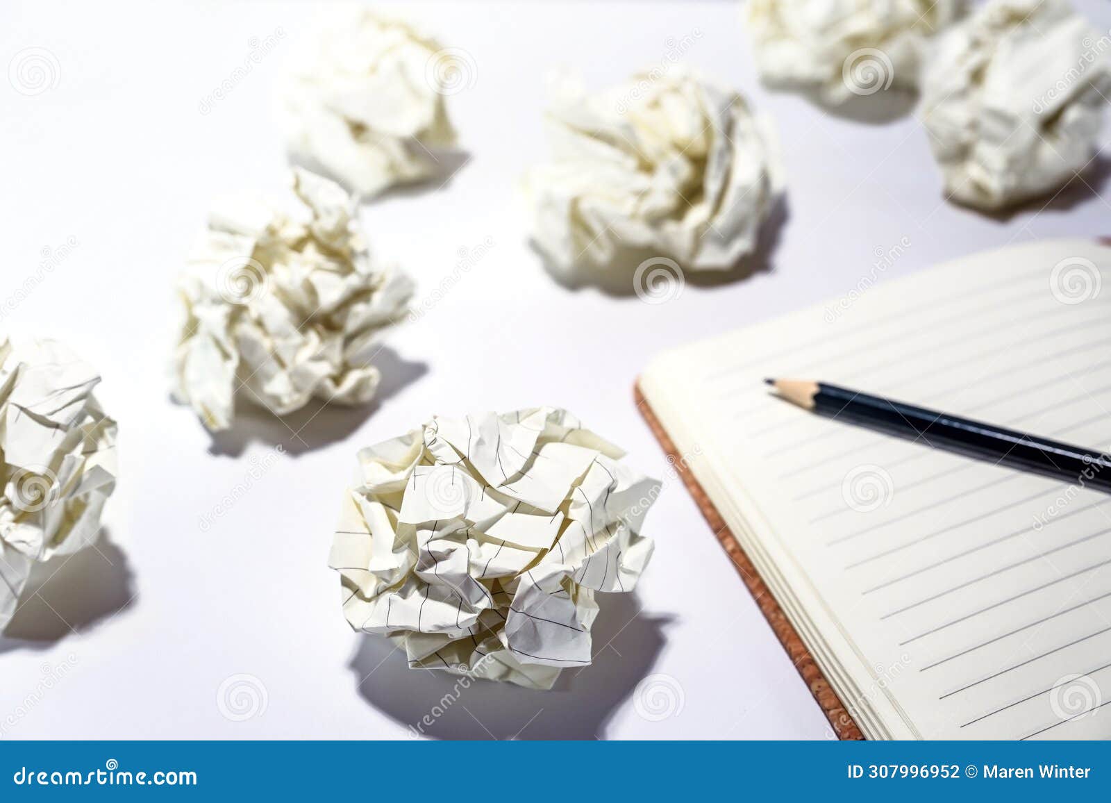 Discarded Crumpled Paper Balls Around an Empty Notebook with a Pencil ...