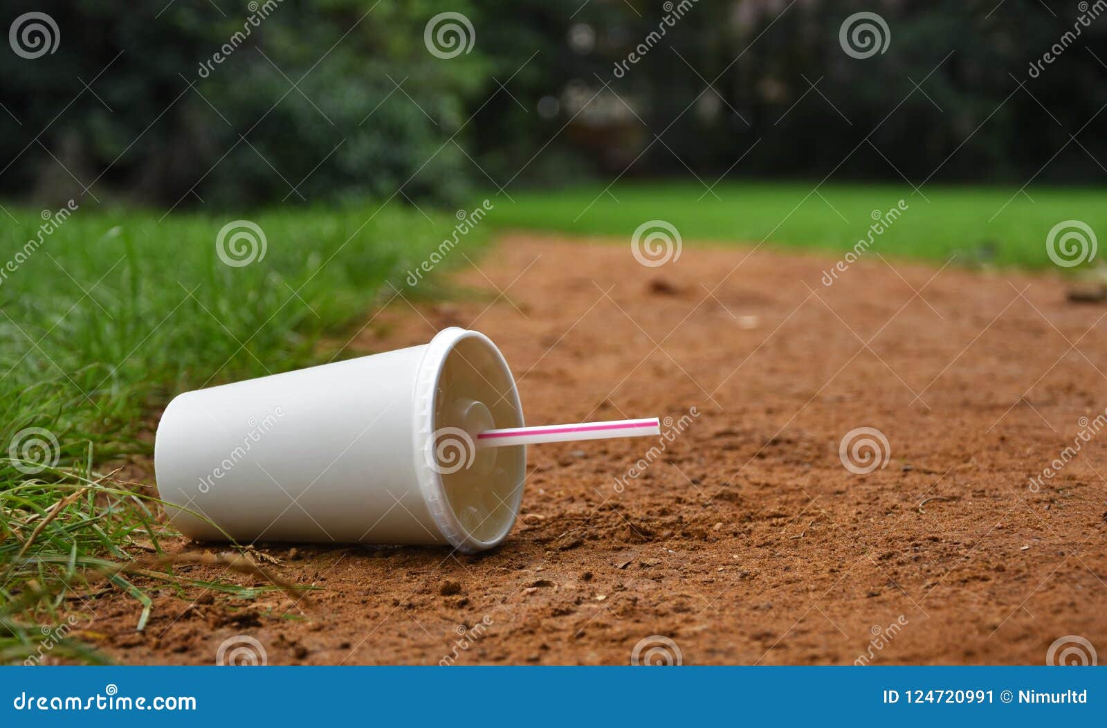 Discarded Drink Container with Straw Litters a Path in a Park Stock ...