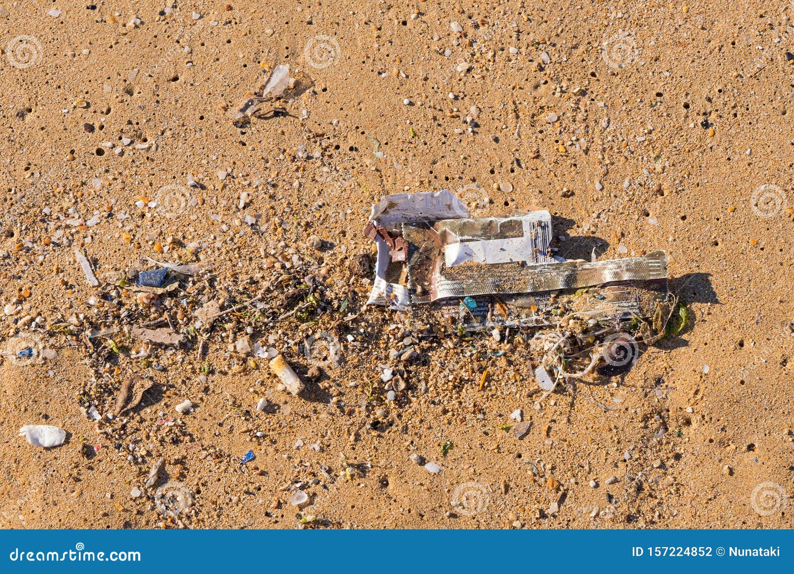 Discarded Garbage by Wave on Beach, Cigarette Butt, Plastic Packaging ...