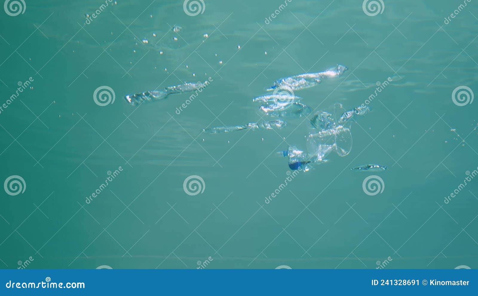 Discarded Plastic Bottles and Cups Drifting Underwater in Blue Water ...