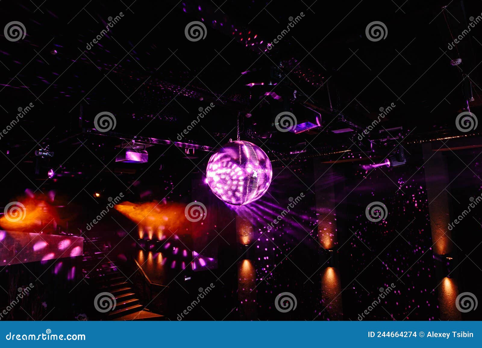 Disco Ball Hanging on the Ceiling of the Disco Rays of Light are ...