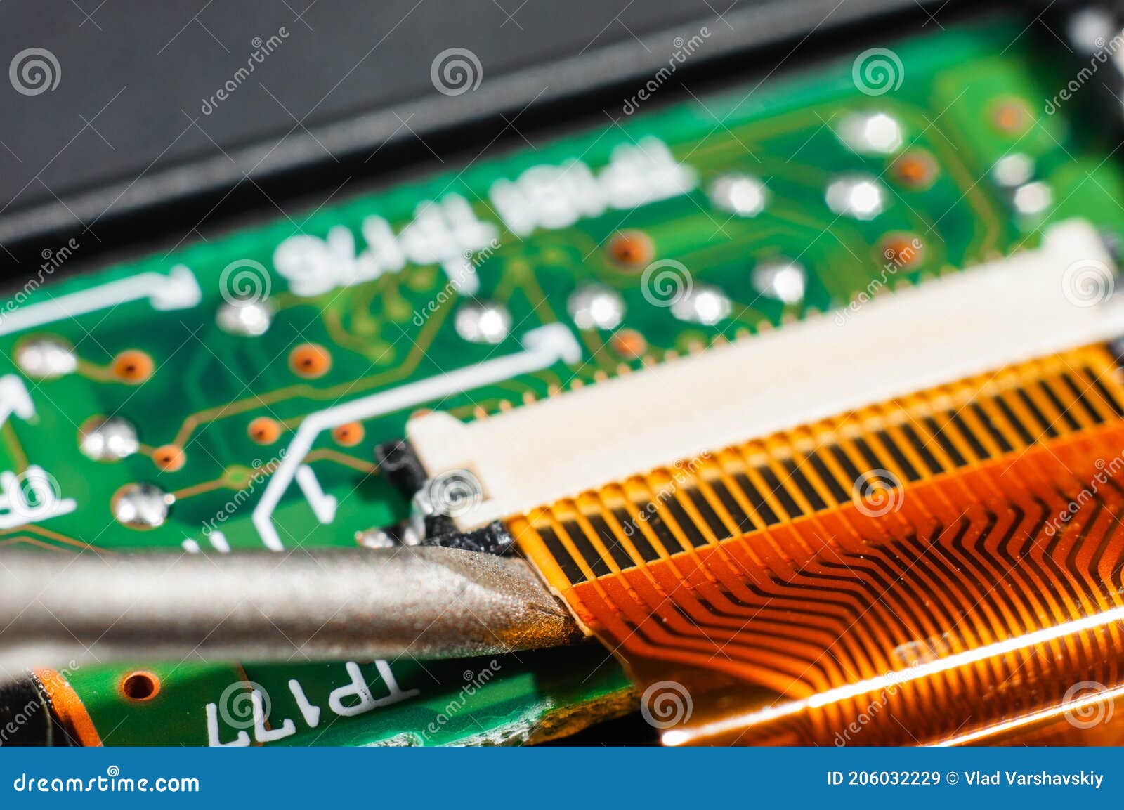 Disconnecting the Chip from the Flat Cable with a Screwdriver, Close-up ...