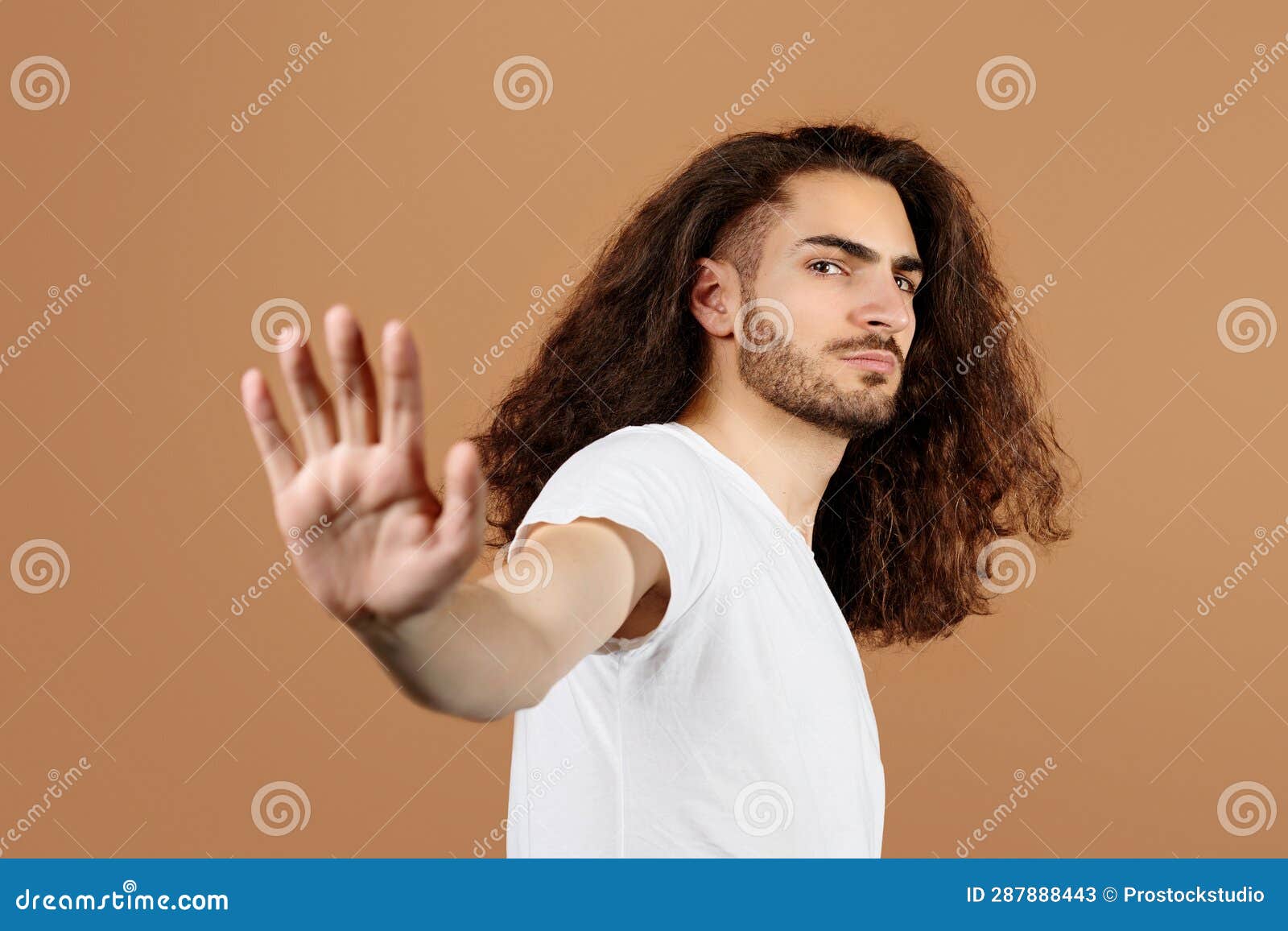 Discontented Hispanic Guy Gesturing Stop Standing Over Beige Background ...