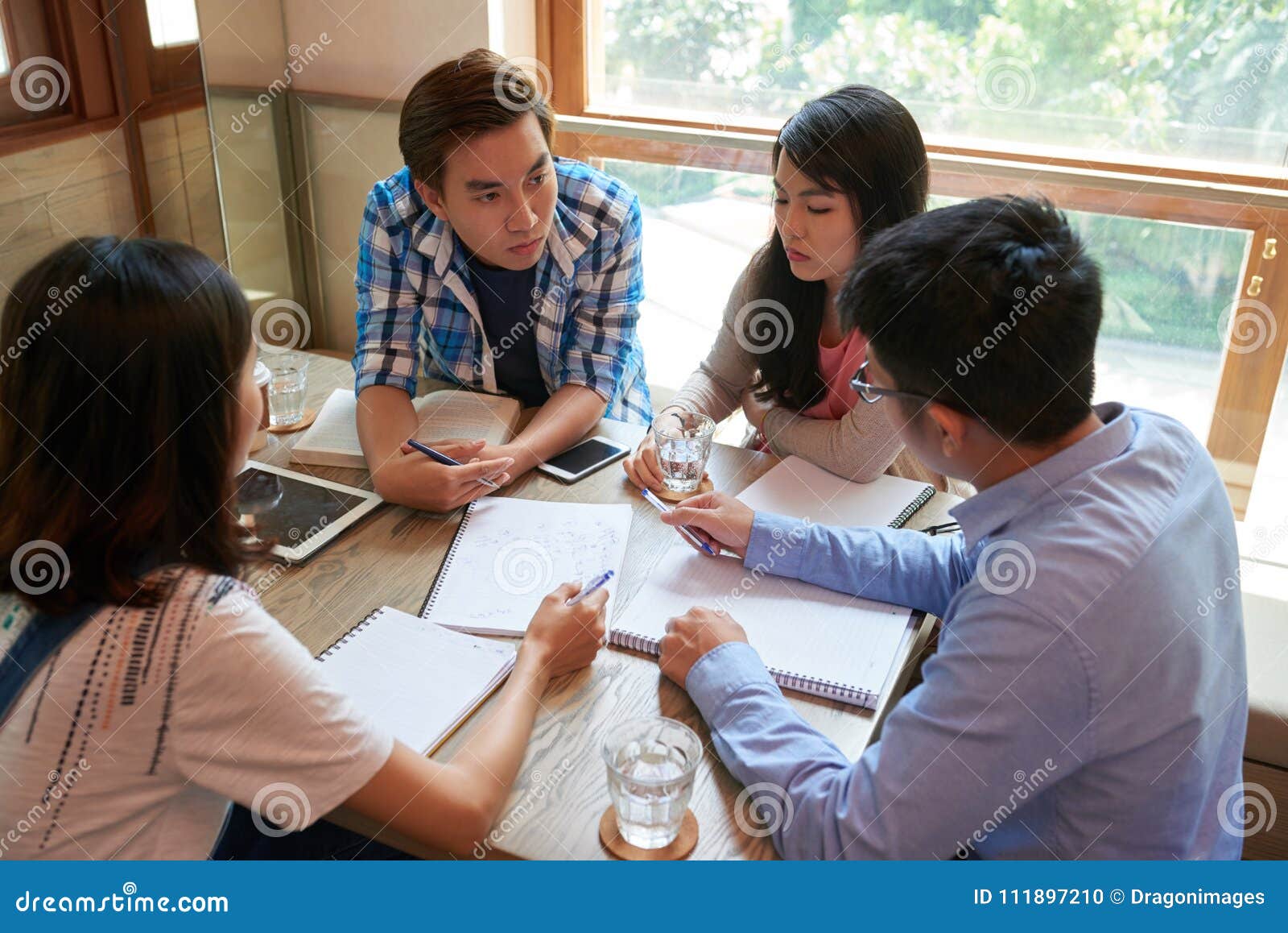 Discusing Educational Project Stock Photo - Image of cafe, homework ...