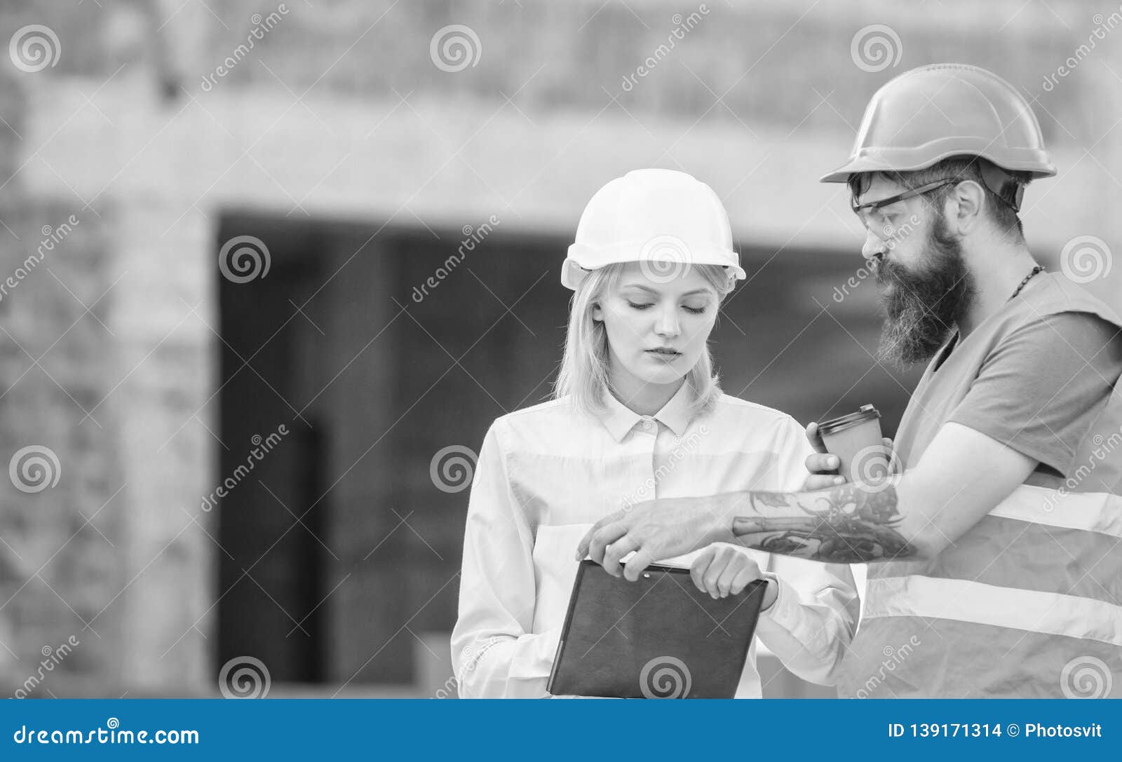 Discuss Progress Plan. Woman Engineer and Builder Communicate ...