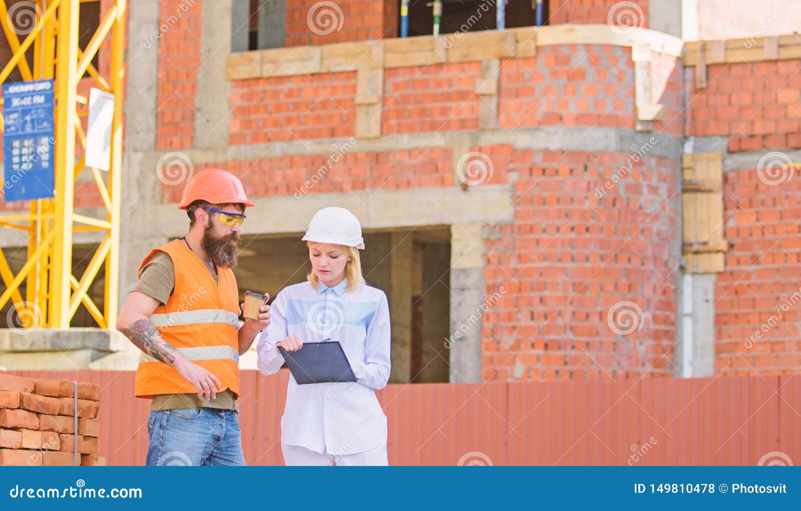 Discuss Progress Plan. Woman Engineer and Builder Communicate ...