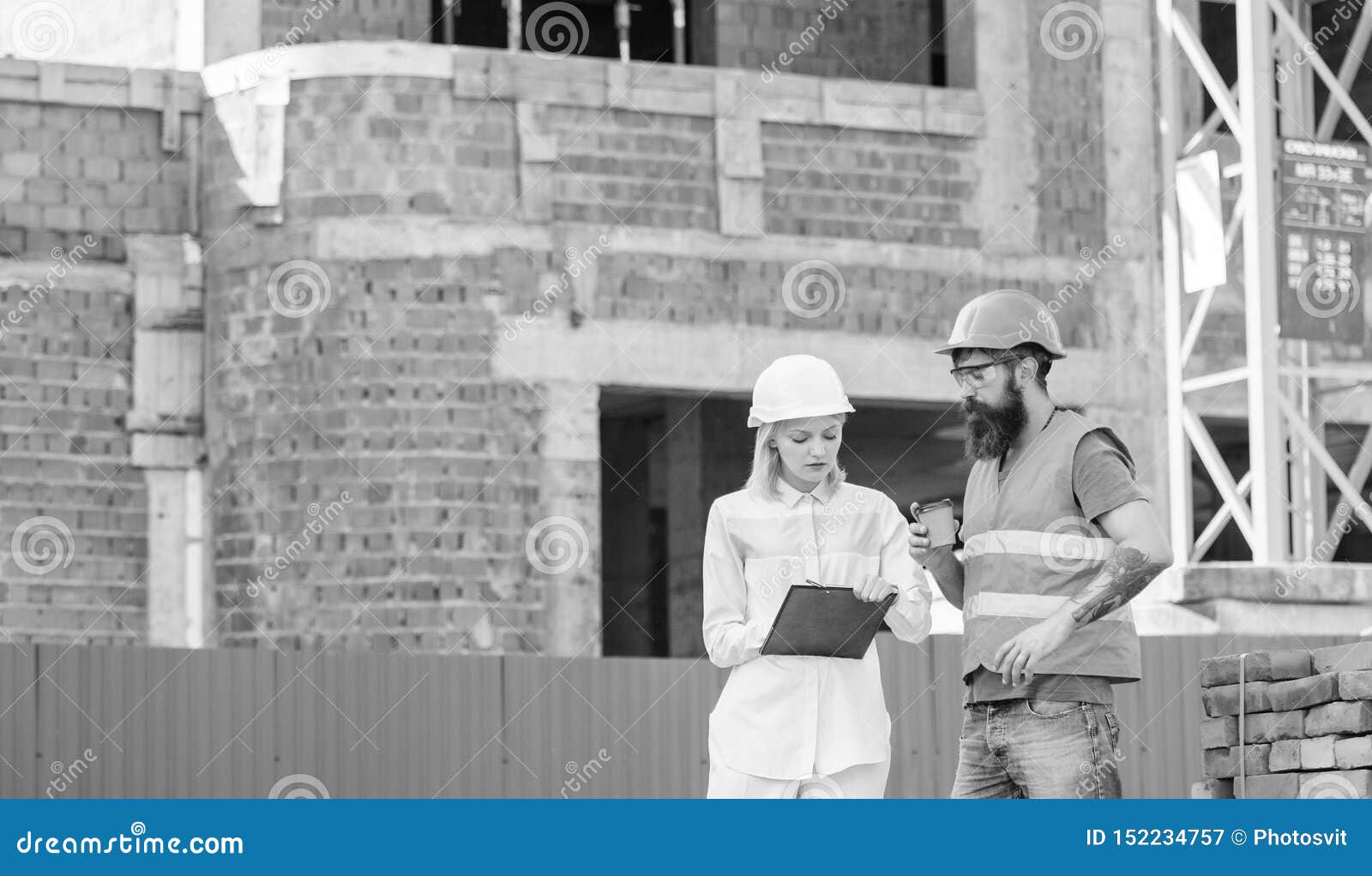 Discuss Progress Plan. Woman Engineer and Builder Communicate ...