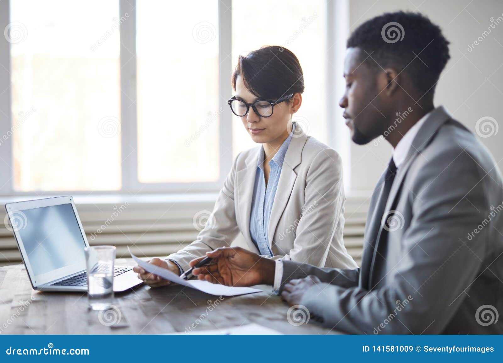 Discussing document stock image. Image of businesswoman - 141581009