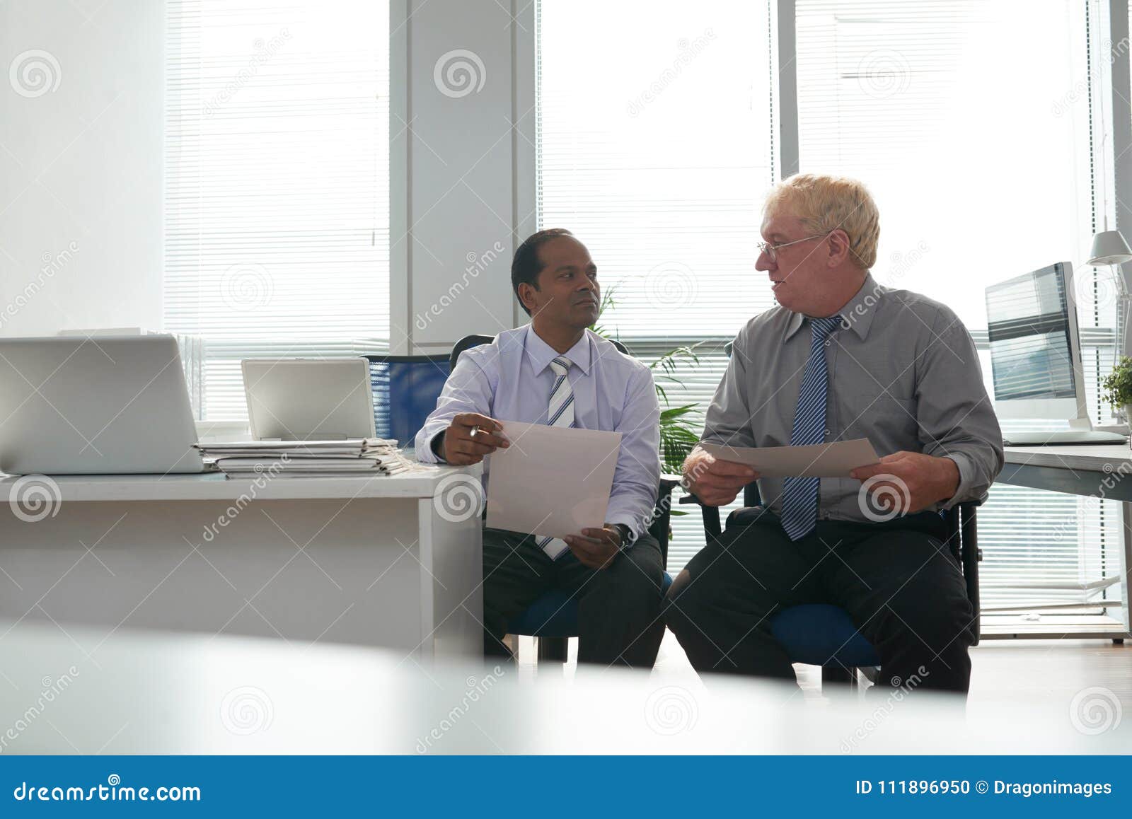 Discussing documents stock photo. Image of caucasian - 111896950