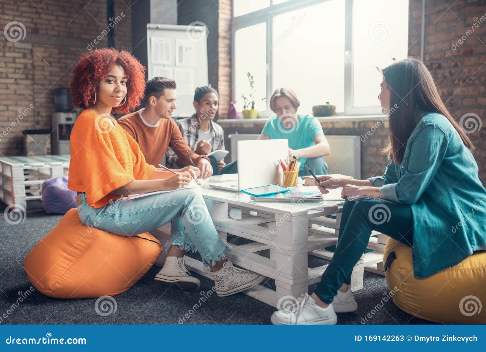 Group of Students Sitting at the Table and Discussing Their Group ...