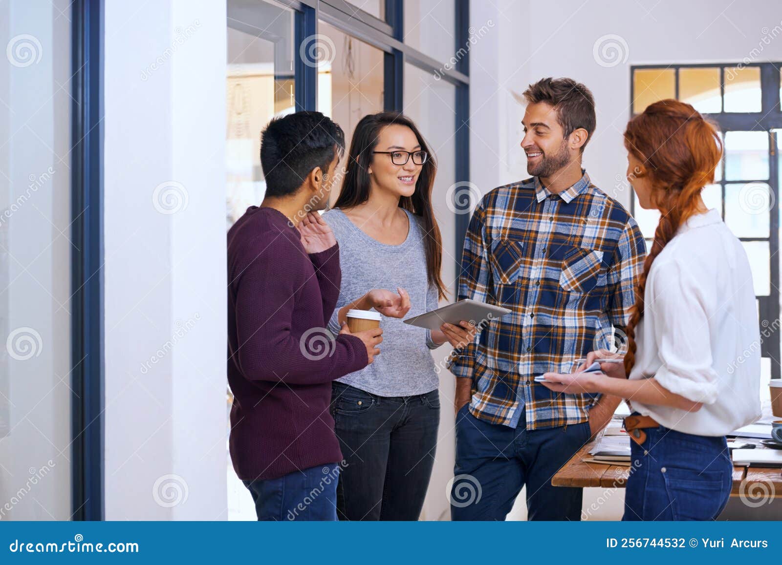 Discussing the New Designs. a Group of Young Designers Discussing Work ...