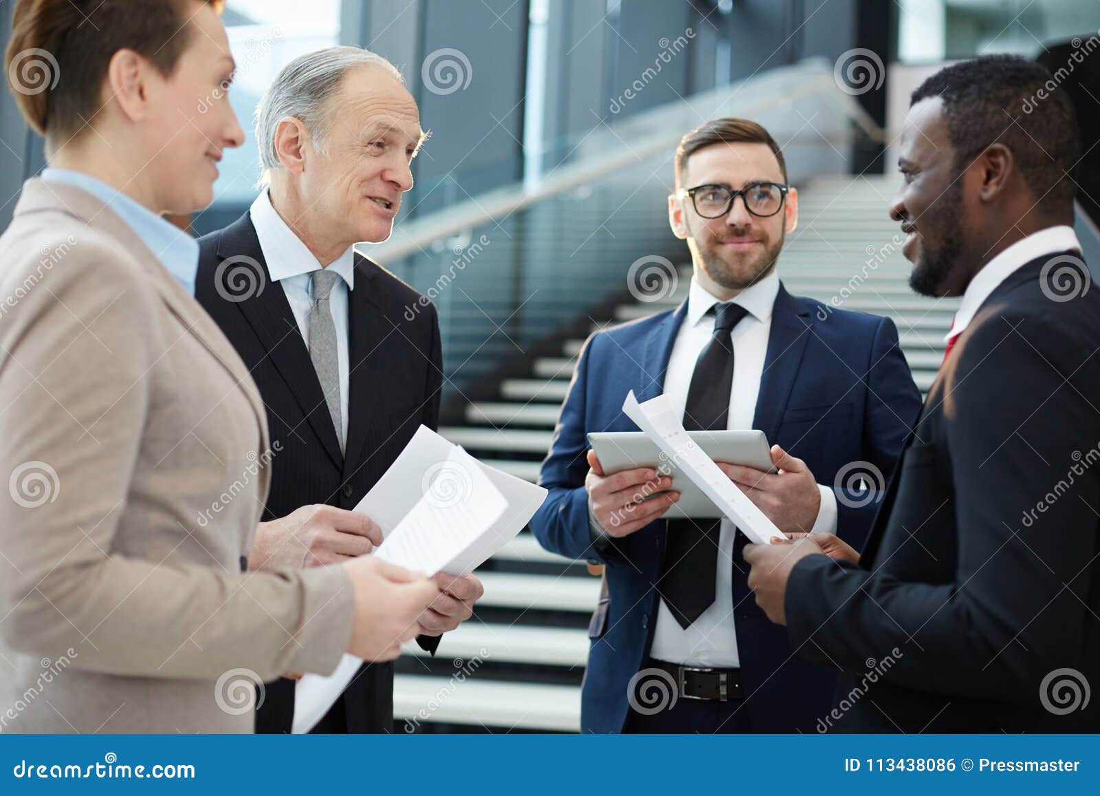 Discussing reports stock photo. Image of adult, airport - 113438086