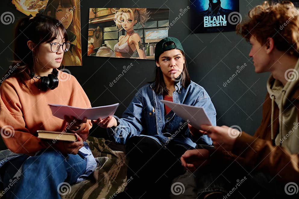Discussing Script in Creative Workspace Surrounded by Art Stock Image ...