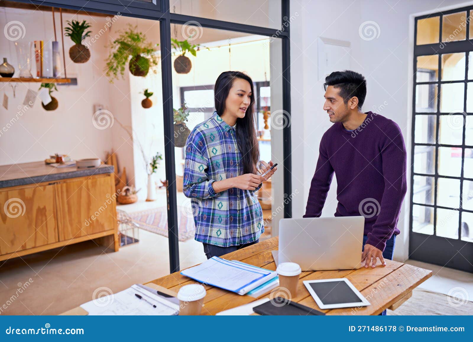 Discussing Some Creative Ideas. Two Young Designers Discussing Ideas in ...