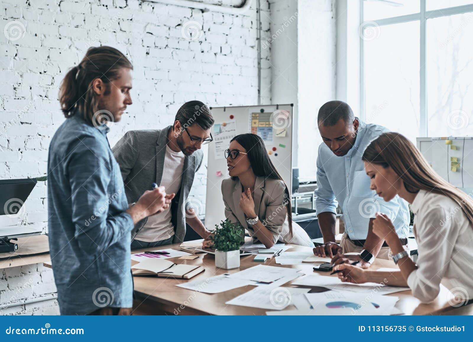 Discussing Strategy. Group of Young Business People Working and Stock ...