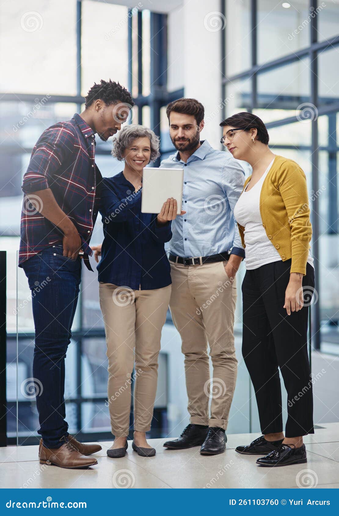 Discussing Their Plans. a Group of Creatives Working Together on a Digital Tablet in an Office ...
