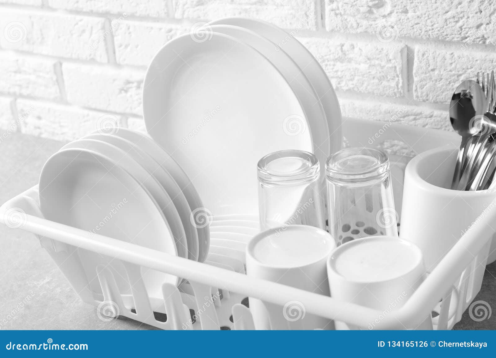 Dish Drainer with Clean Plates on Table Stock Photo - Image of china ...