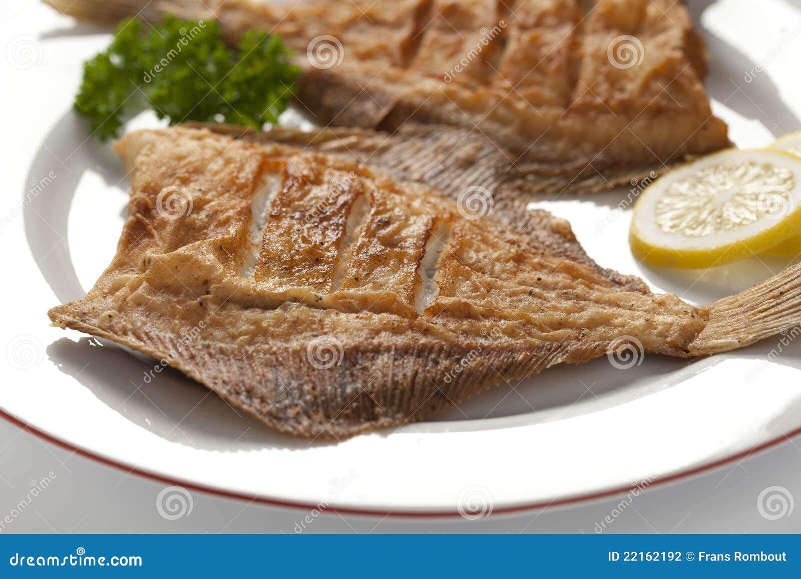 Fried Plaice Fillet With Herb Butter And Lemon On A Plate On A Wooden ...