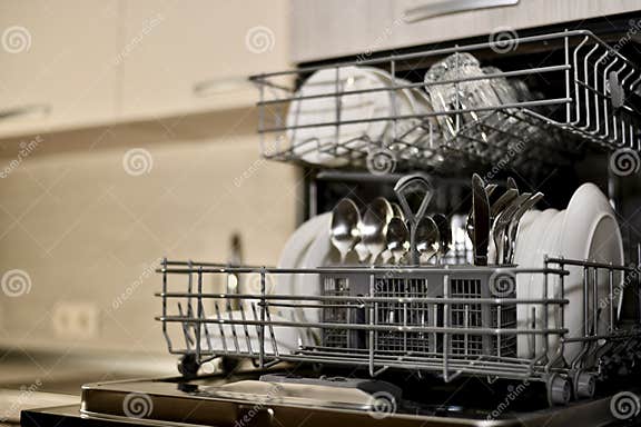 A Dishwasher with Dishes Built in the Kitchen Cabinet Opened an Angle ...