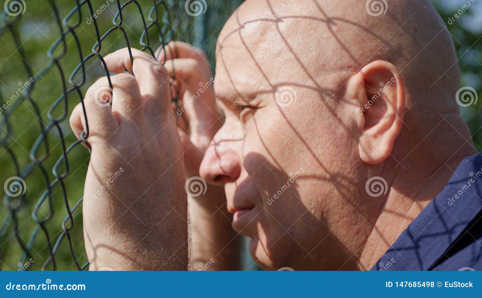 Disillusioned Man Image Looking Sad Thru a Metallic Fence Stock Photo ...