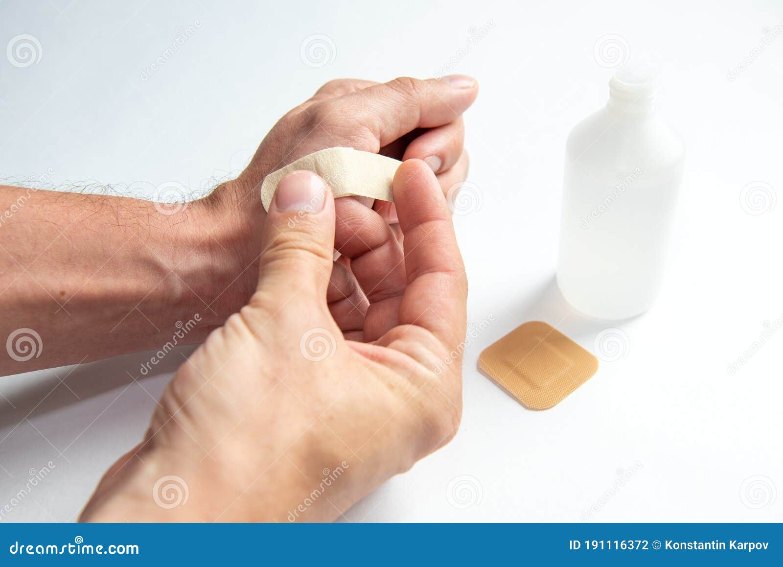 Disinfecting the Wound on the Hand and Applying a Patch Stock Photo ...