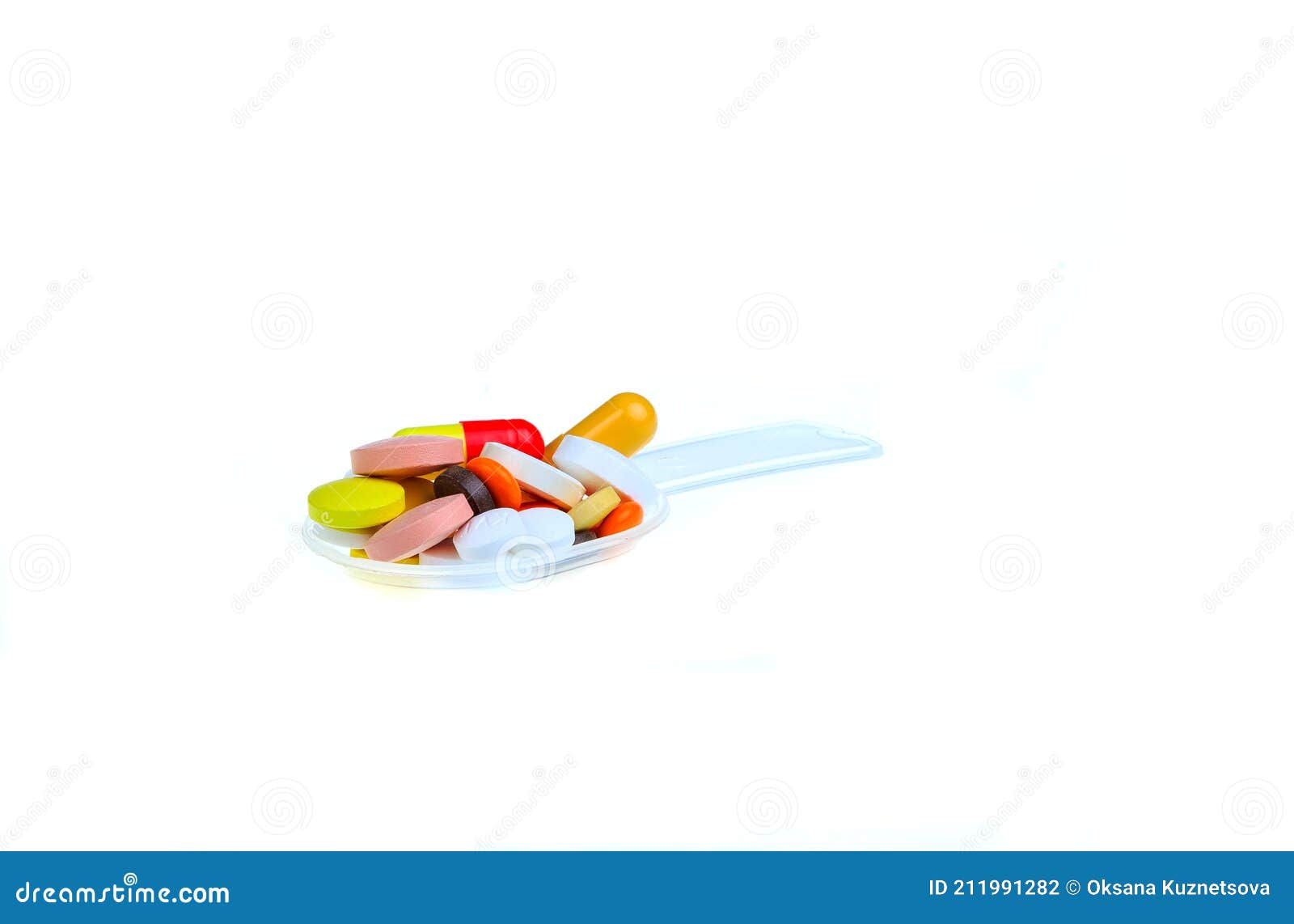 Dispenser Spoon with Tablets and Capsules on a White Background ...