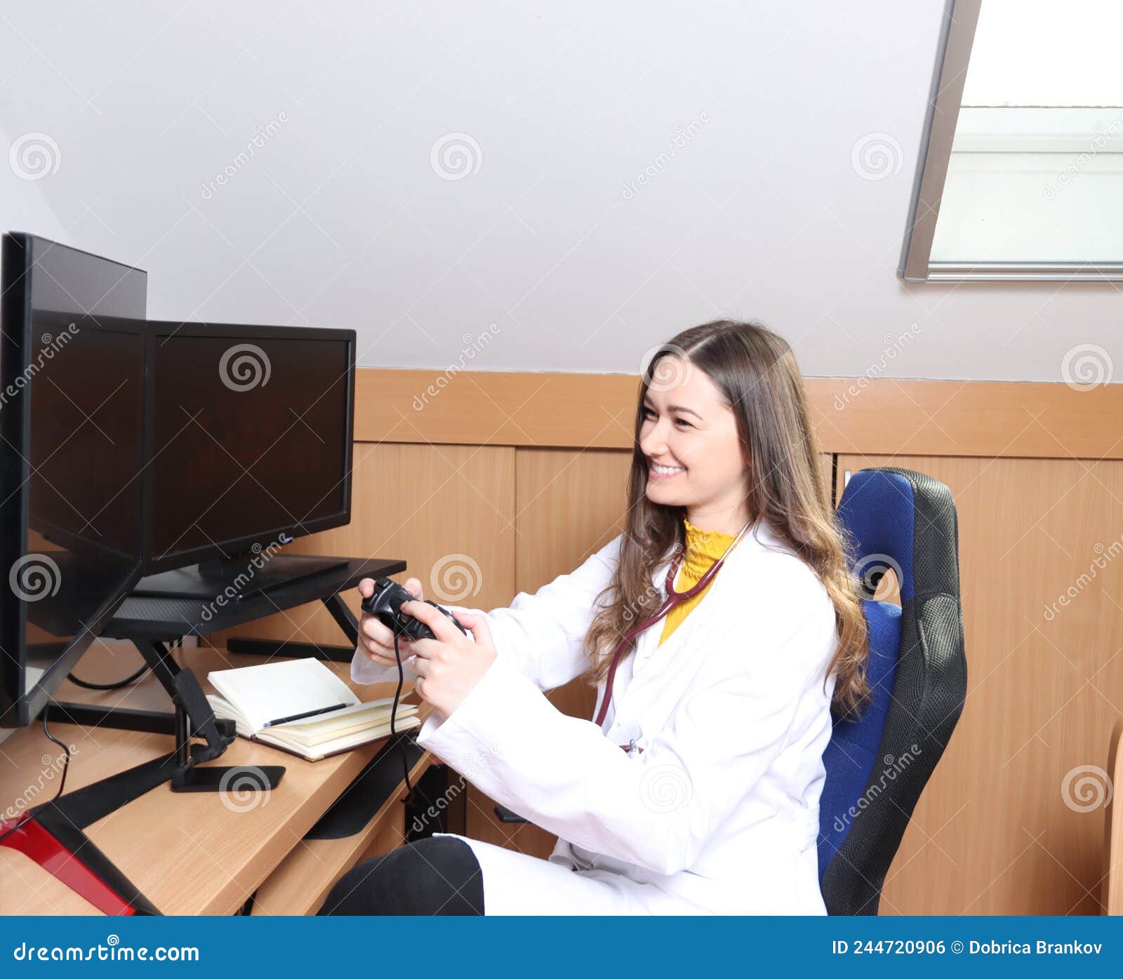 A Display of a Young Female Doctor Playing on a Computer Stock Photo ...