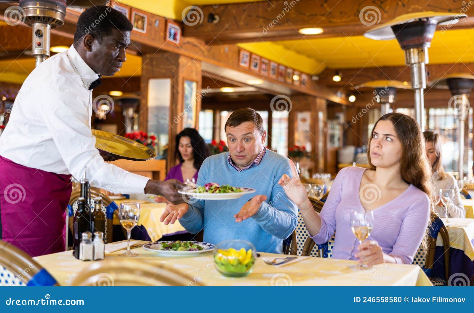Displeased Guests Conflicting with Waiter Stock Photo - Image of ...