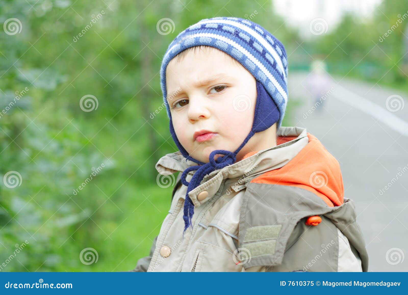 Displeased little boy stock image. Image of green, staring - 7610375