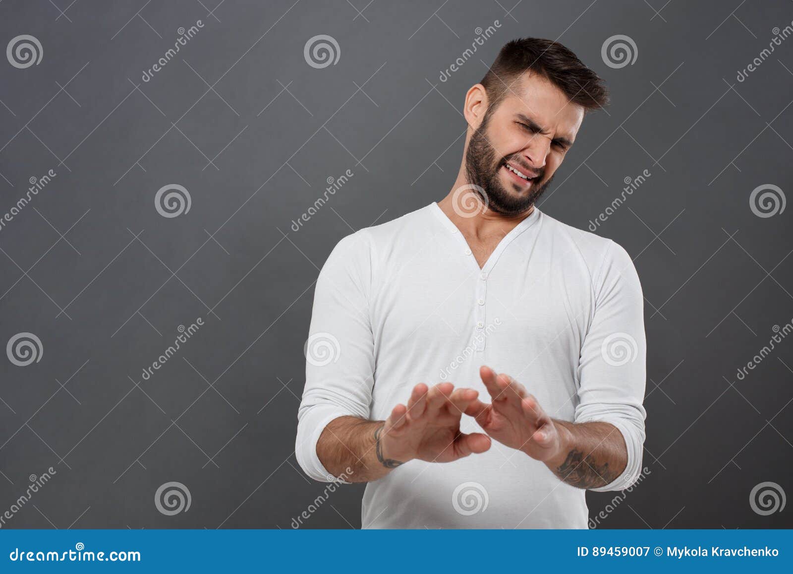Displeased Man Refusing, Stretching Hands To Camera Over Grey ...