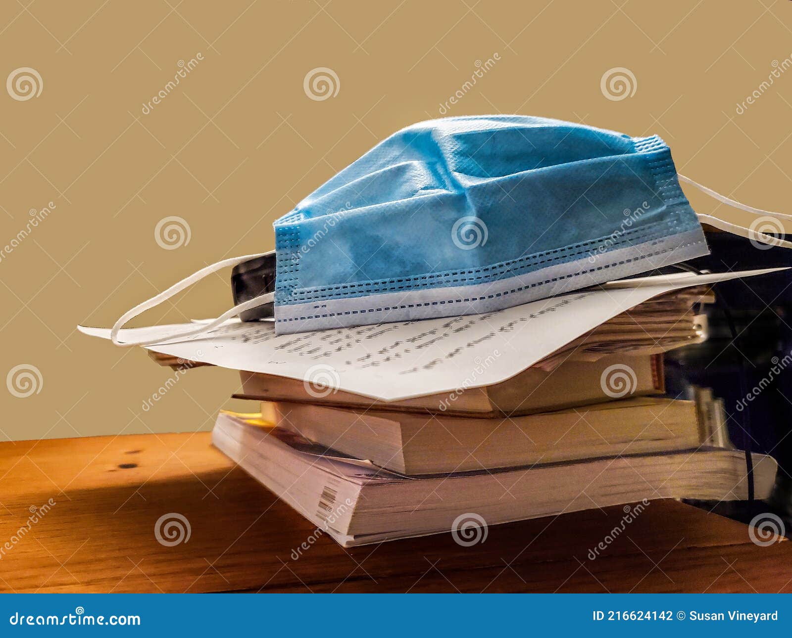 Disposable Face Mask on Top of a Stack of University Books Sitting on a ...