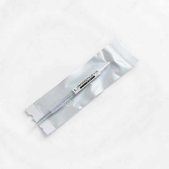 A Disposable Needle in Sterile Packaging Placed on a White Surface ...
