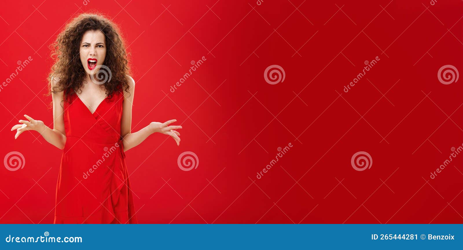 Dissatisfied Angry And Attractive Curly Haired Female In Stylish Red
