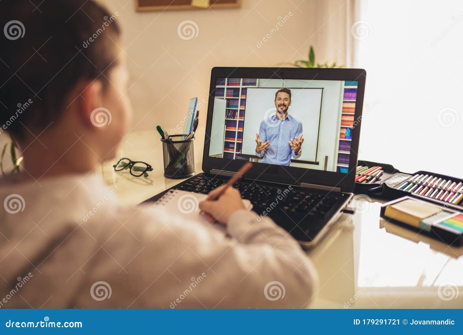 A Schoolboy Boy Studies at Home and Does School Homework. a Home ...
