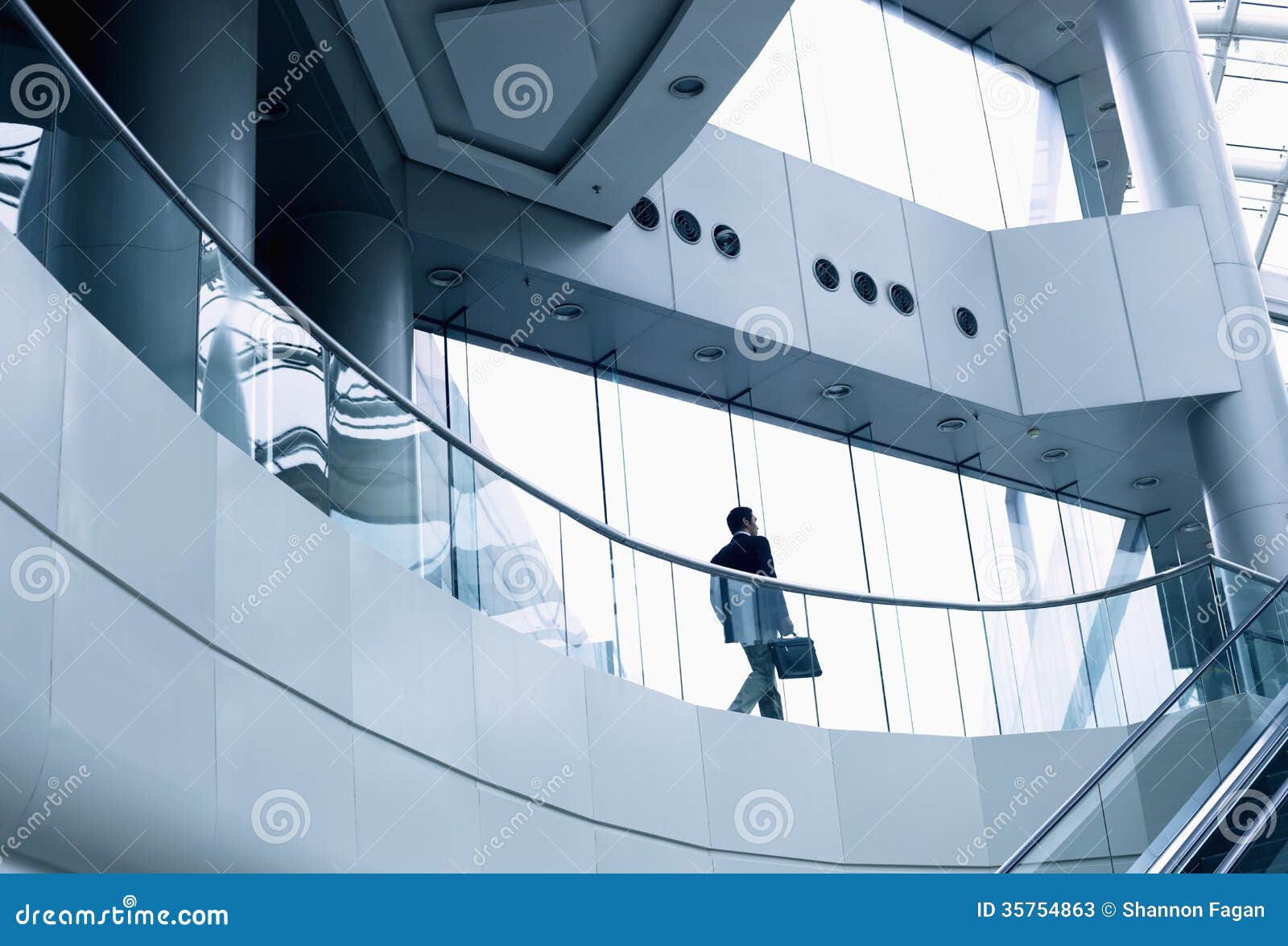 Distant Businessman Walking in a Modern Office Building Stock Image ...