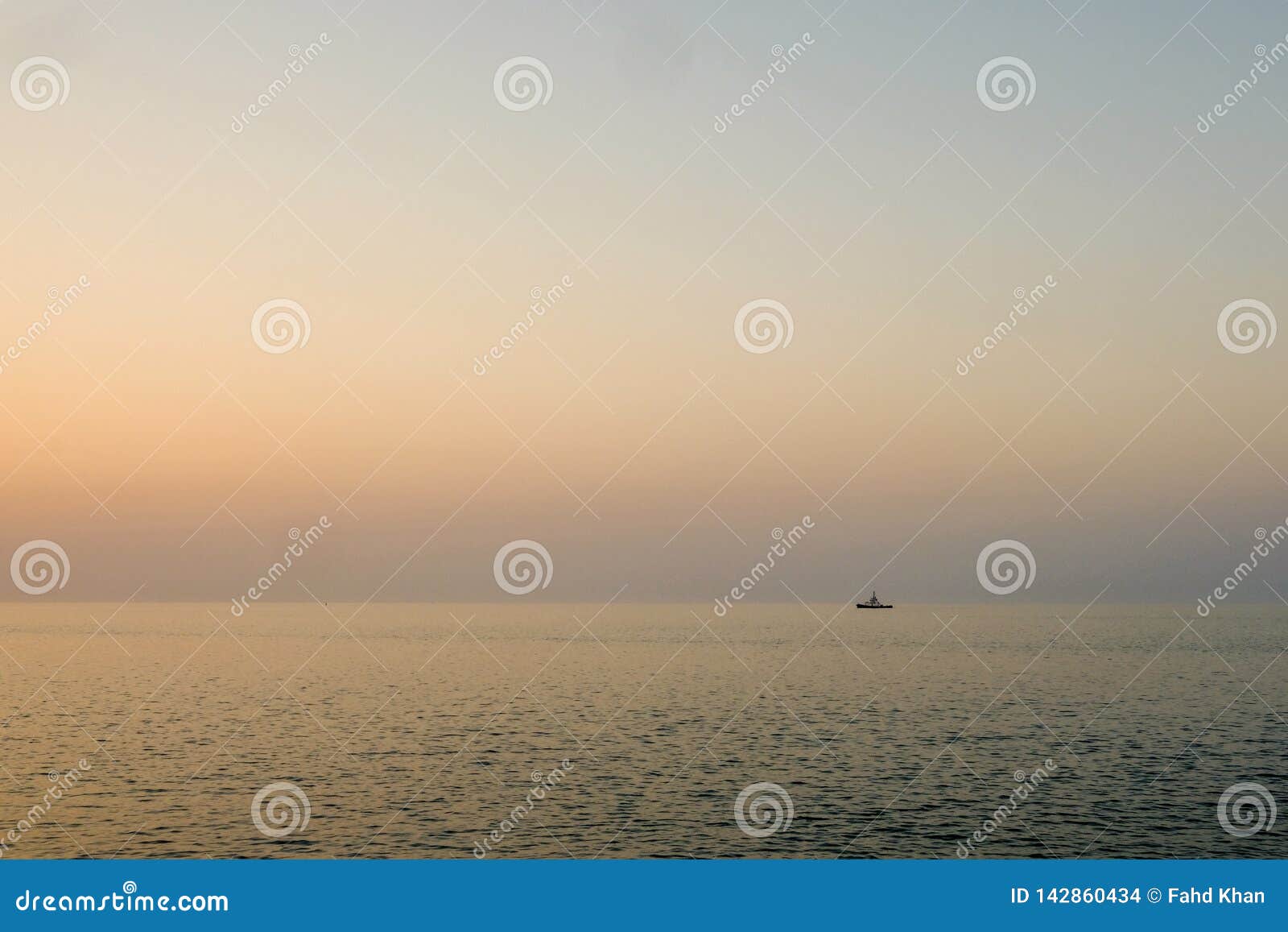 Distant Cargo Ship in a Calm Sea at Evening Editorial Stock Image ...
