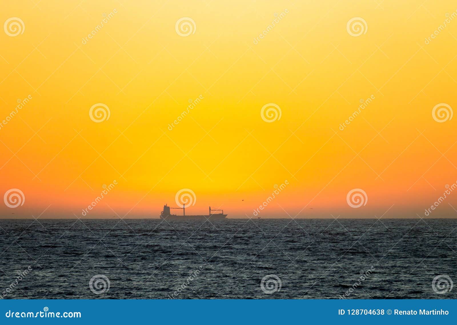 Distant Cargo Ship at Sunset Stock Photo - Image of dusk, blue: 128704638